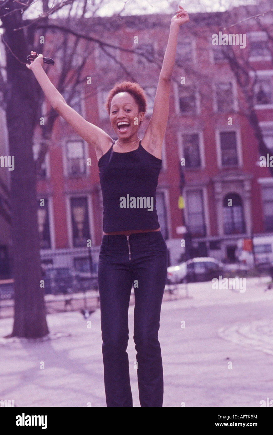 Woman exulting in park Stock Photo - Alamy