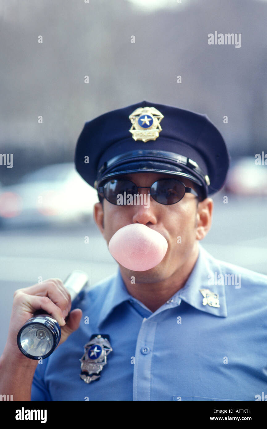 Police officer blowing gum Stock Photo - Alamy