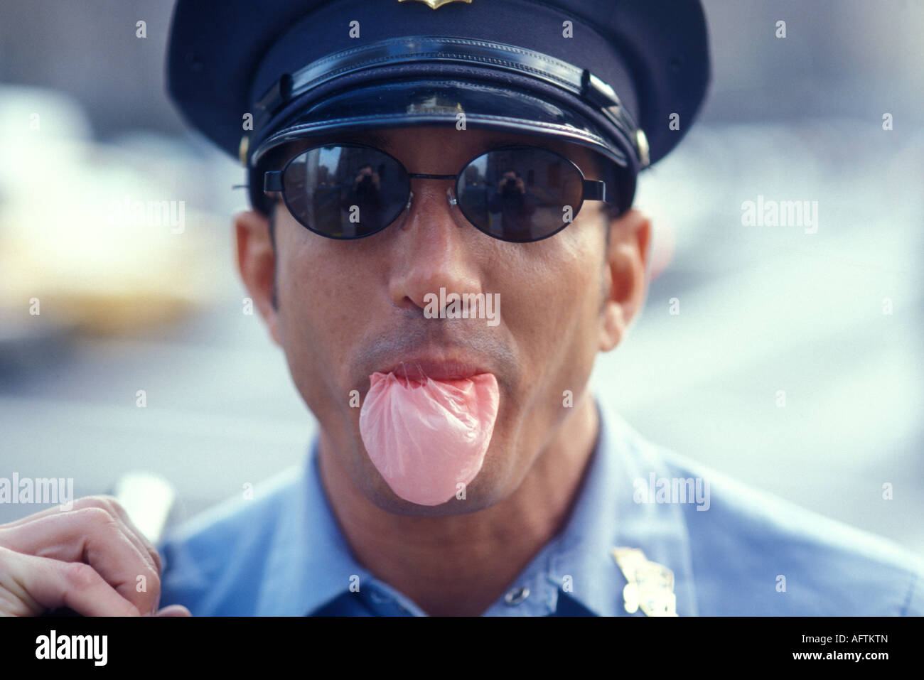 Police officer blowing gum Stock Photo - Alamy