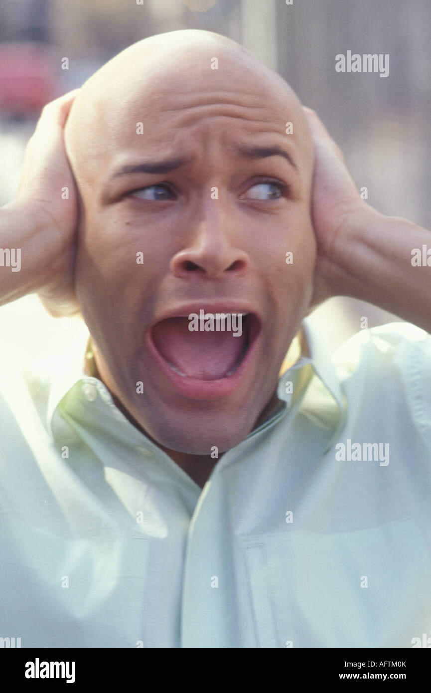 Young man screaming Stock Photo - Alamy