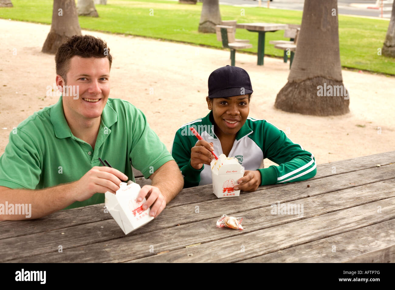Young couple feeding each other at cafe Stock Photo - Alamy