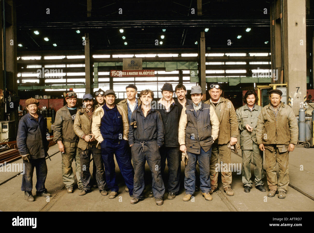 shipyard workers line up for photograph in Ganz Danubius shipyard ...
