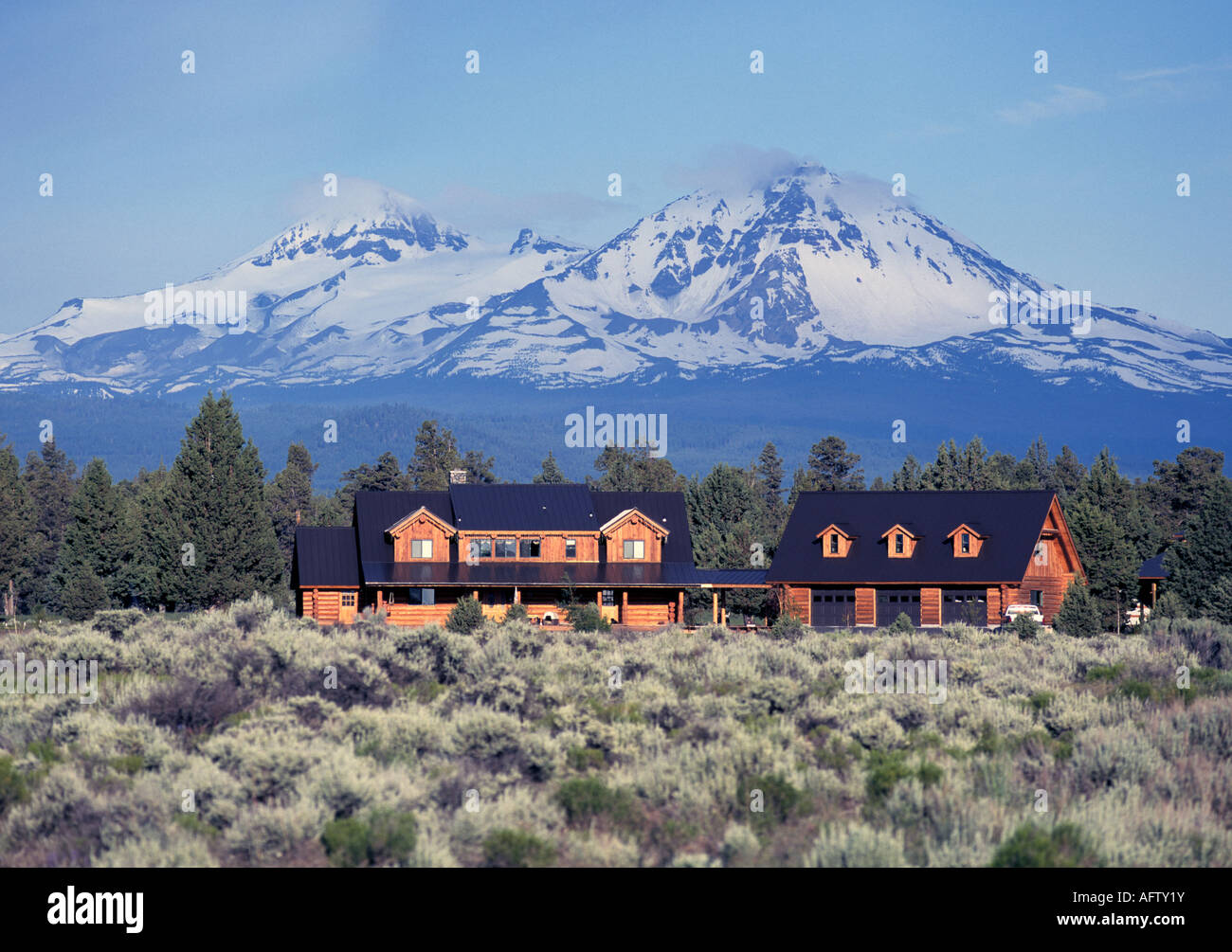 A large log mansion house on the lower slopes of the Sisters peaks in ...