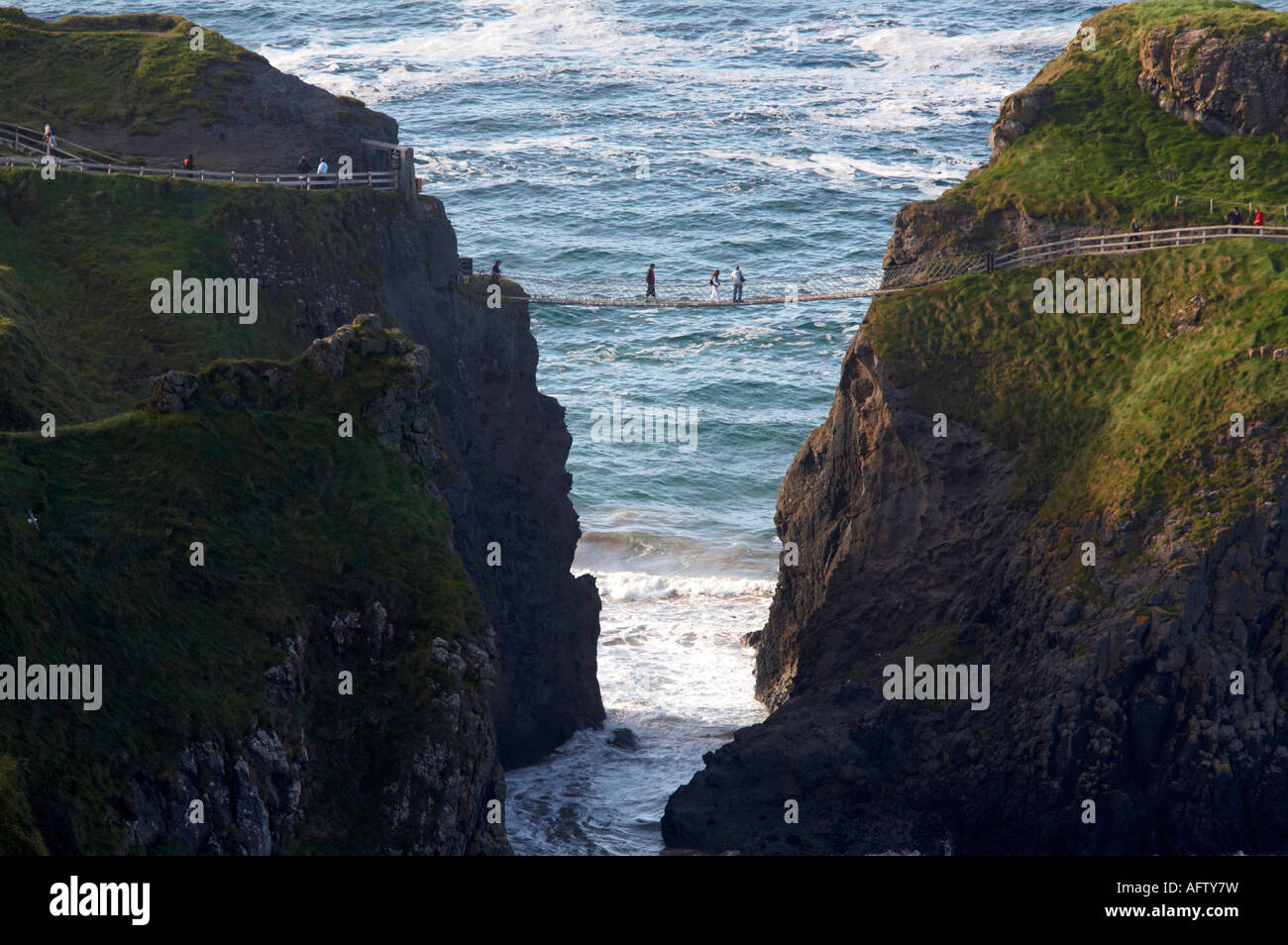 tourists cross the carrick a rede rope bridge on the causeway coast ...