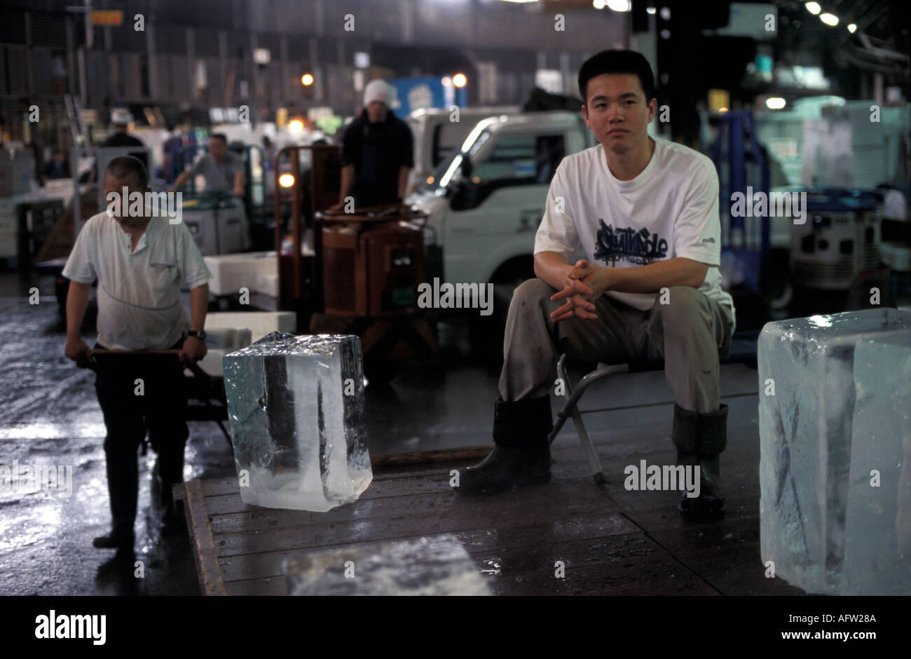 Japanese worker selling ice cubes at Tsukiji Fish Market Tokyo Japan ...
