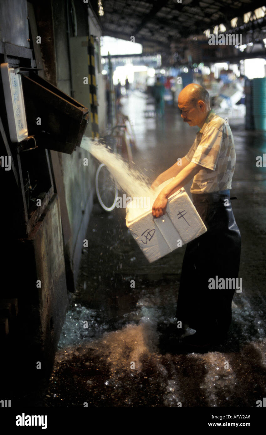 Japanese fishmonger filling his polystyrene box with ice Tsukiji Fish ...