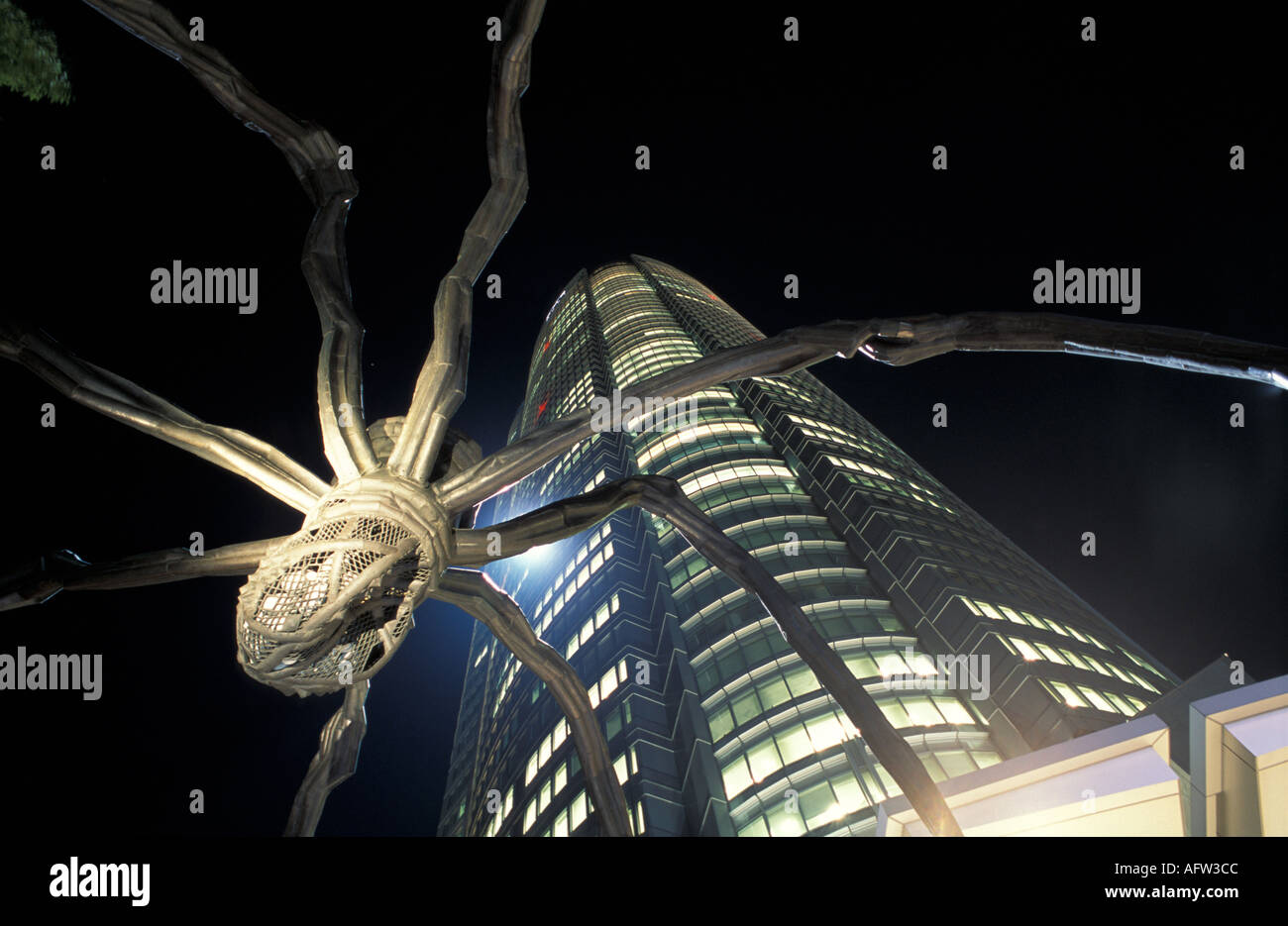 Night view of the giant spider illuminated in front of Mori Tower ...