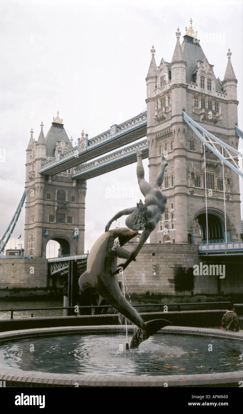 Girl playing with dolphin statue near Tower Bridge London Stock Photo ...