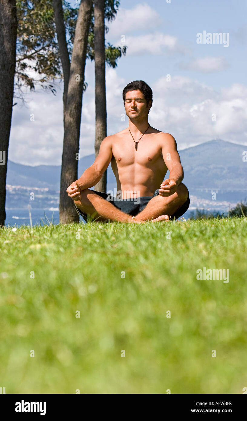 Man sitting on grass outdoor meditating relaxing nature yoga Stock ...