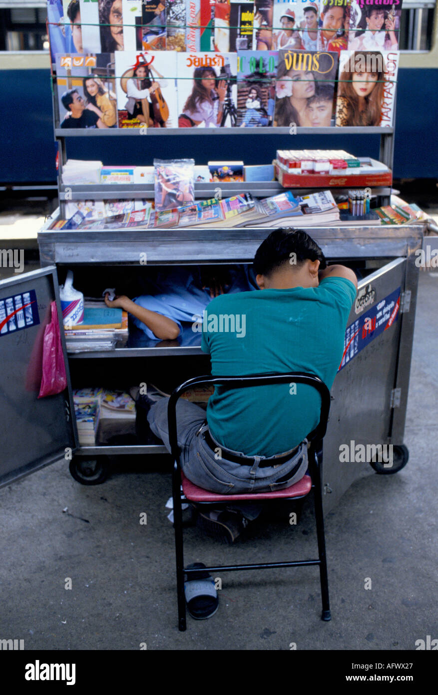 Sleeping magazine seller newspaper stand, he is asleep along with ...