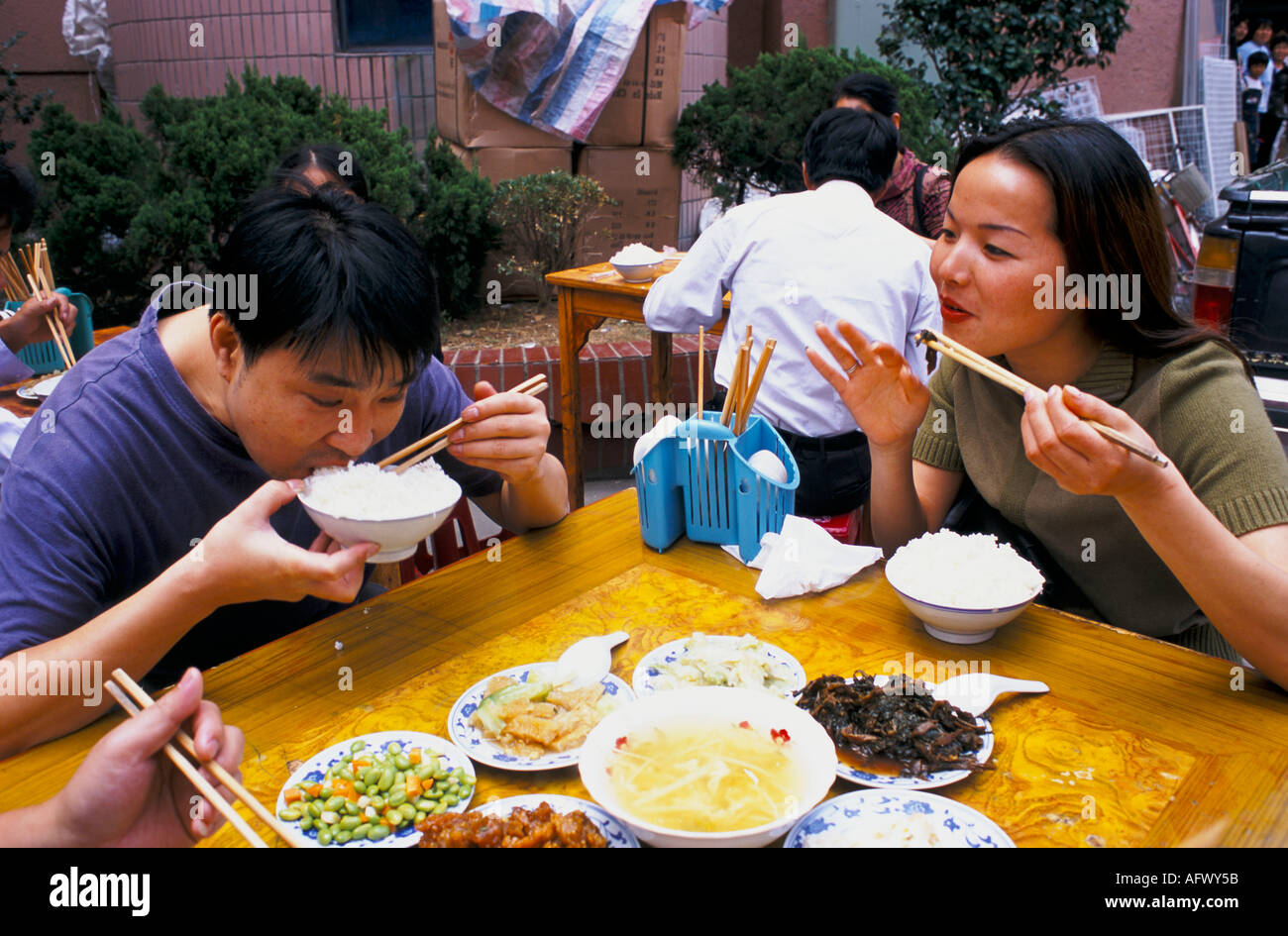 Couple eating chinese food chopsticks hi-res stock photography and ...