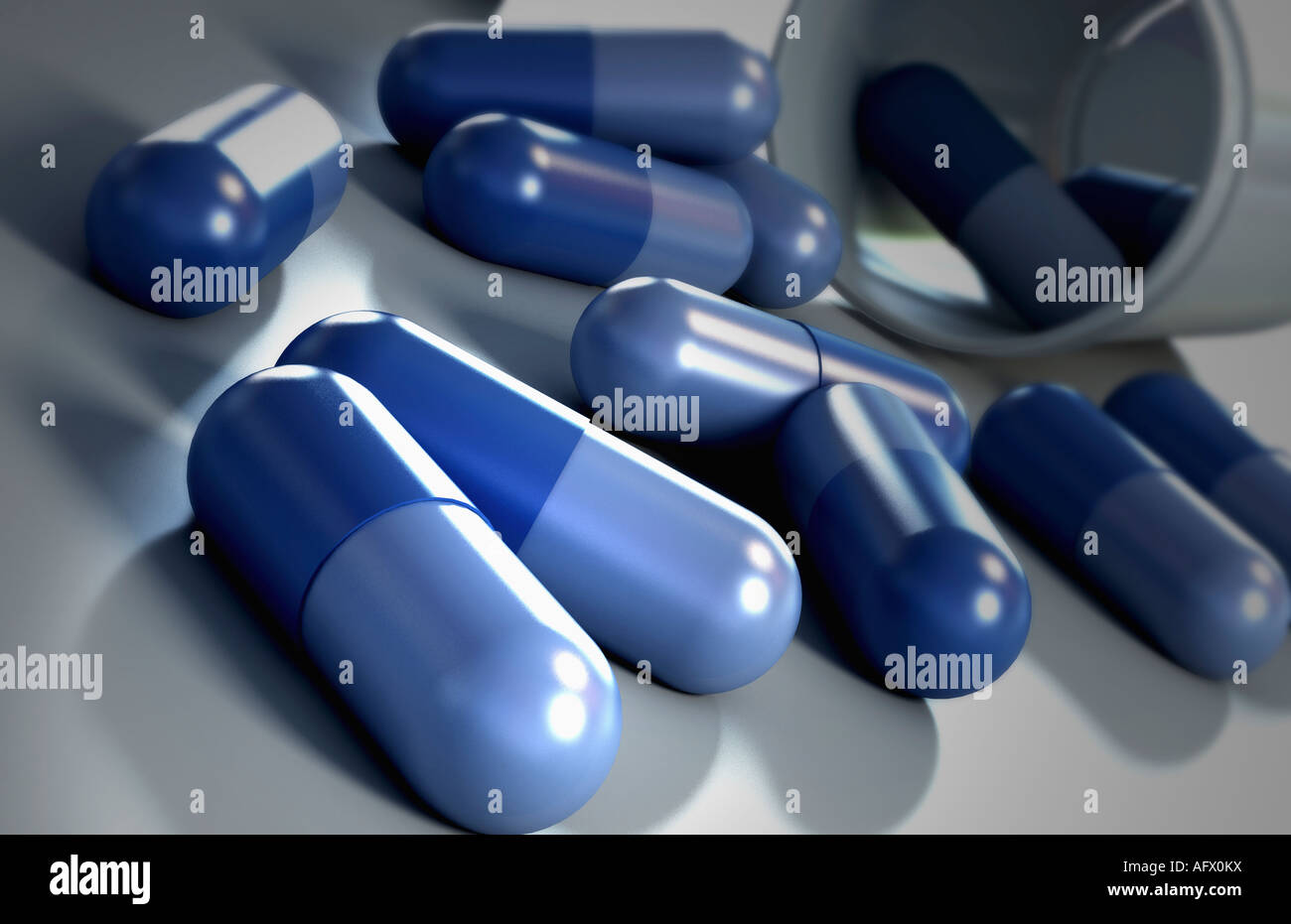Drug capsules spilling from a container Stock Photo - Alamy