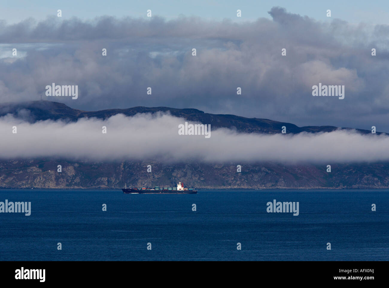 freight ship passing through the north channel past a mist shrouded ...