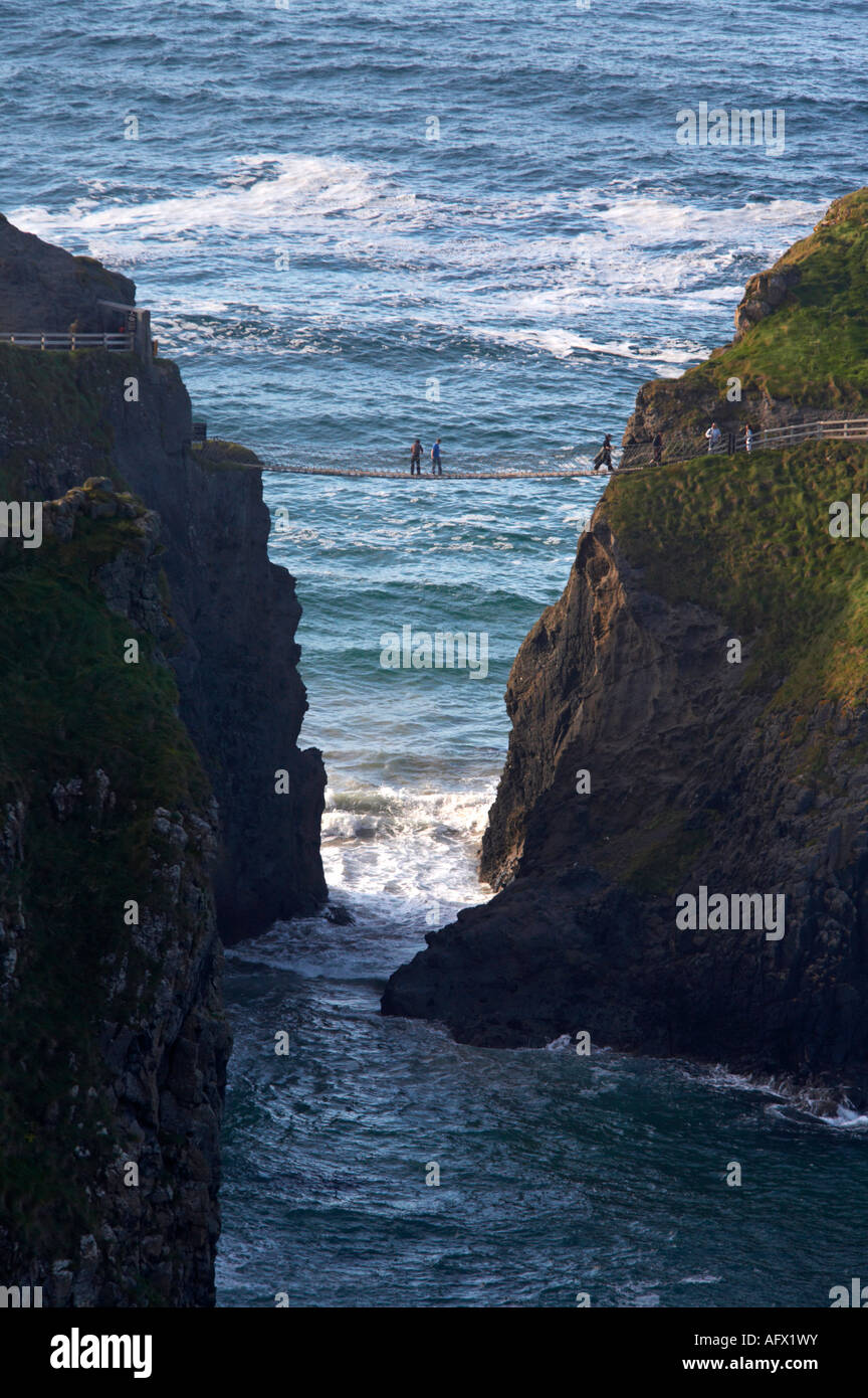 tourists cross the carrick a rede rope bridge on the causeway coast ...