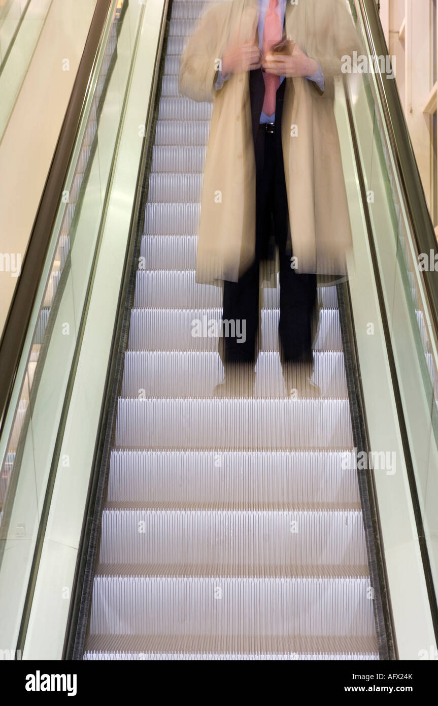 Man coming down escalators Stock Photo - Alamy