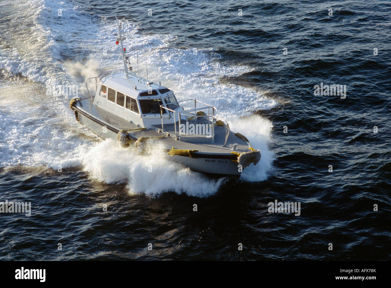 Speeding tug boat Stock Photo - Alamy