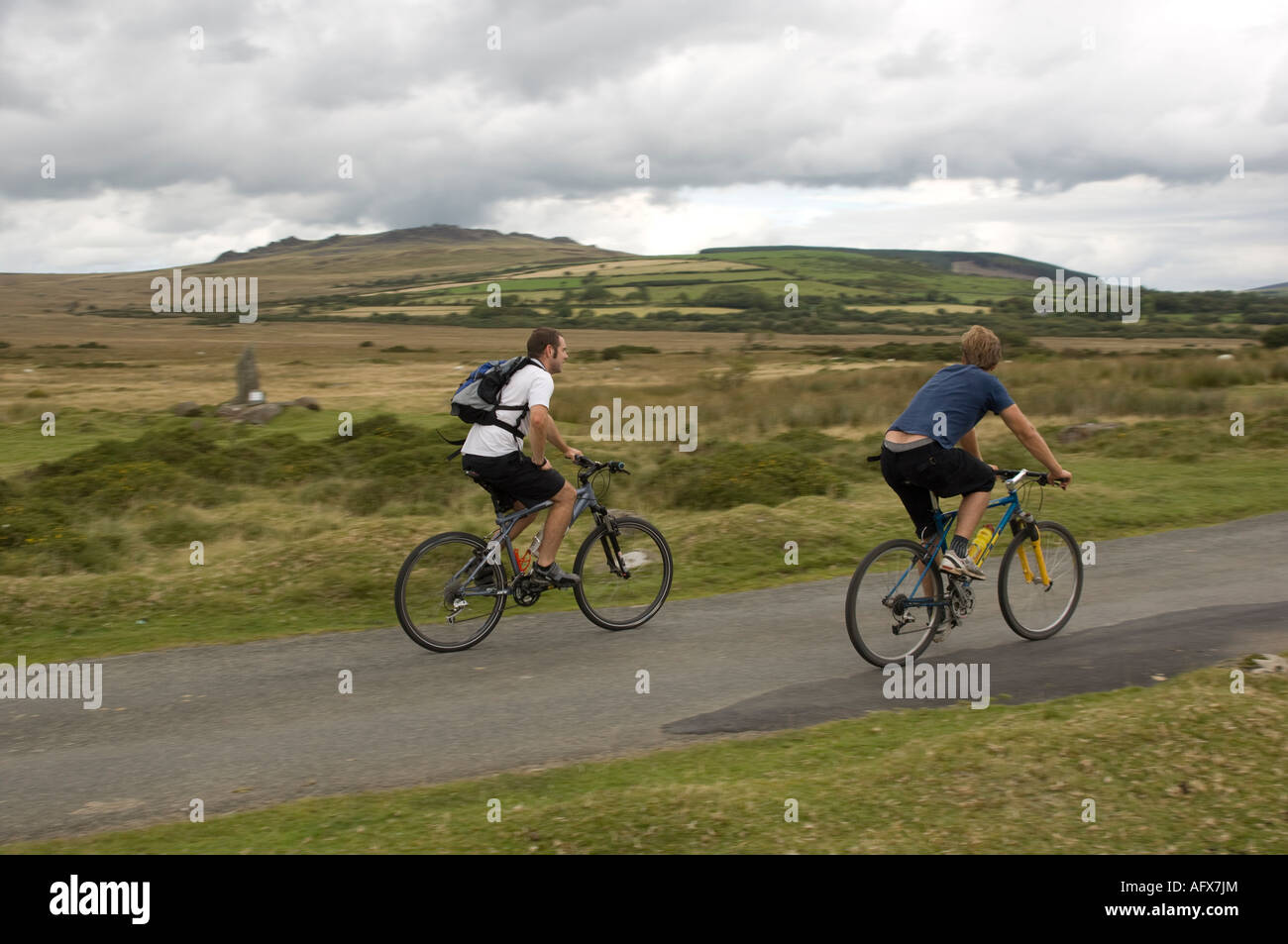 two men cycling Pembrokeshire wales with Carnmenyn , Preseli hills in ...