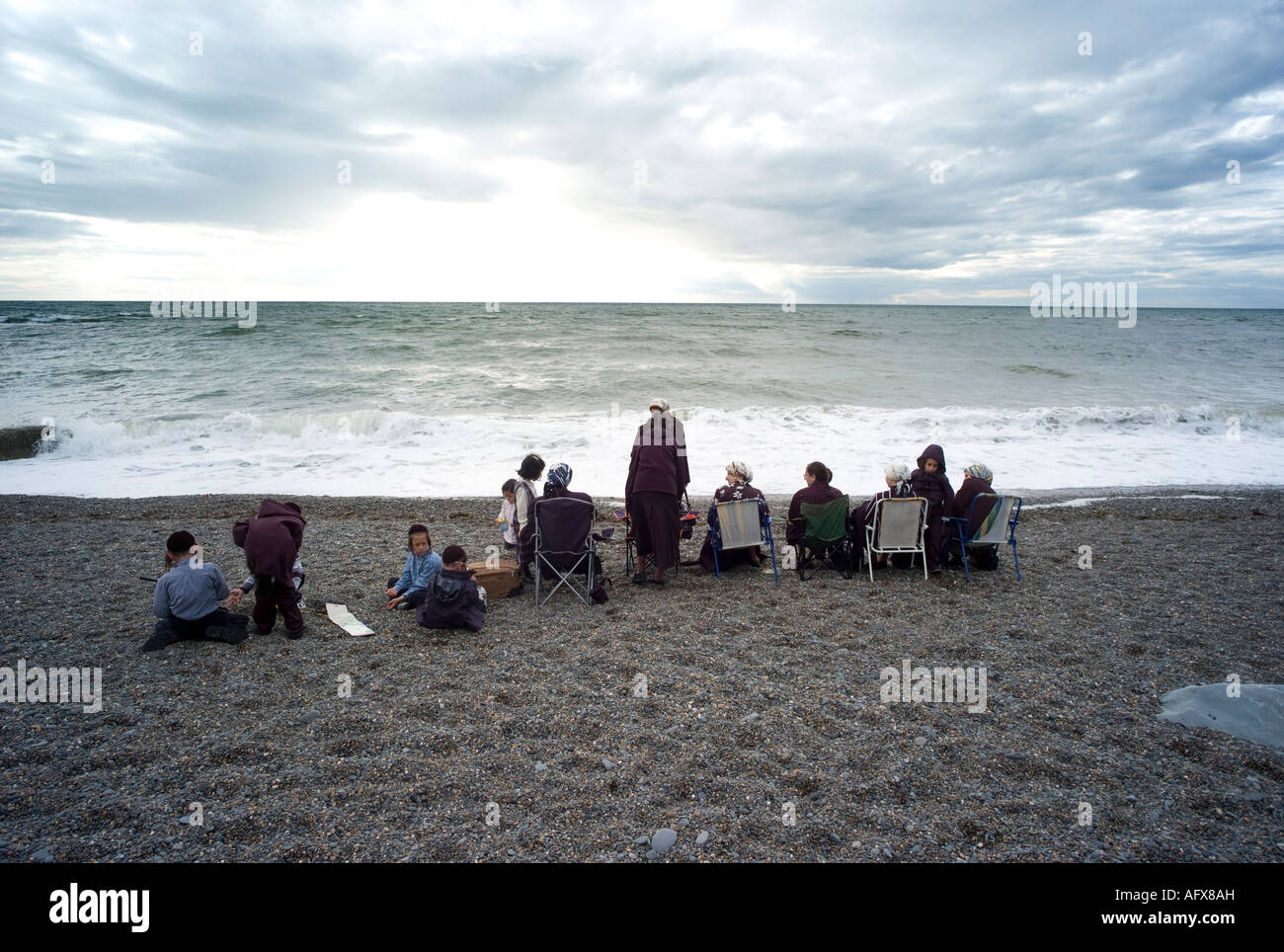 Hassidic orthodox jewish people on the beach Aberystwyth Wales august ...