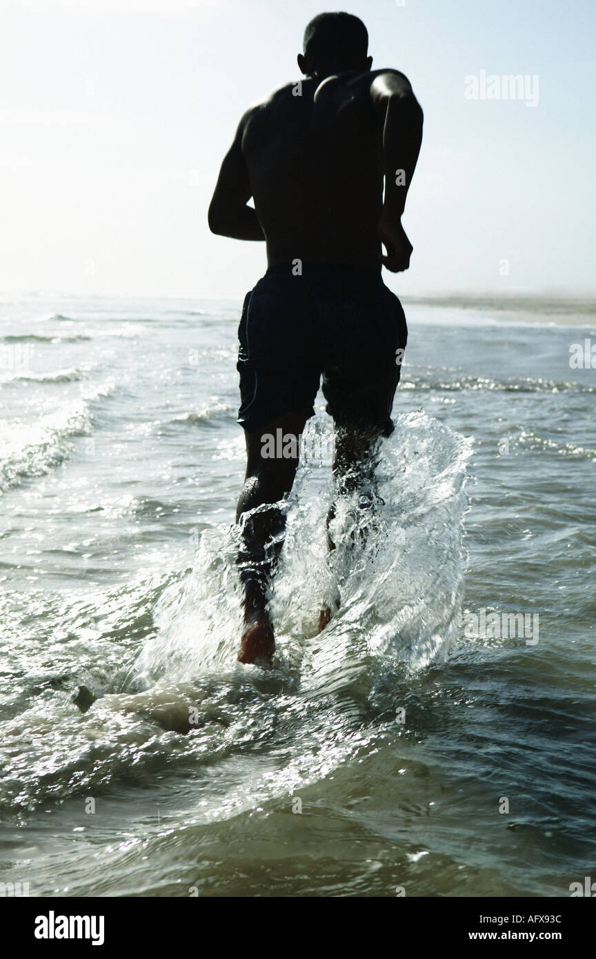 Man running in the water at the sea Stock Photo - Alamy
