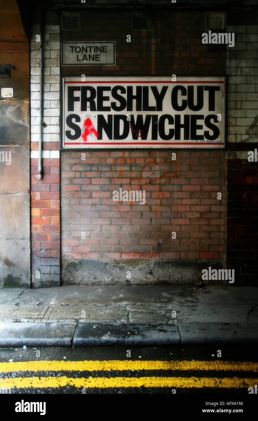 An urban image of a red brick walled arched way with 'freshly cut ...