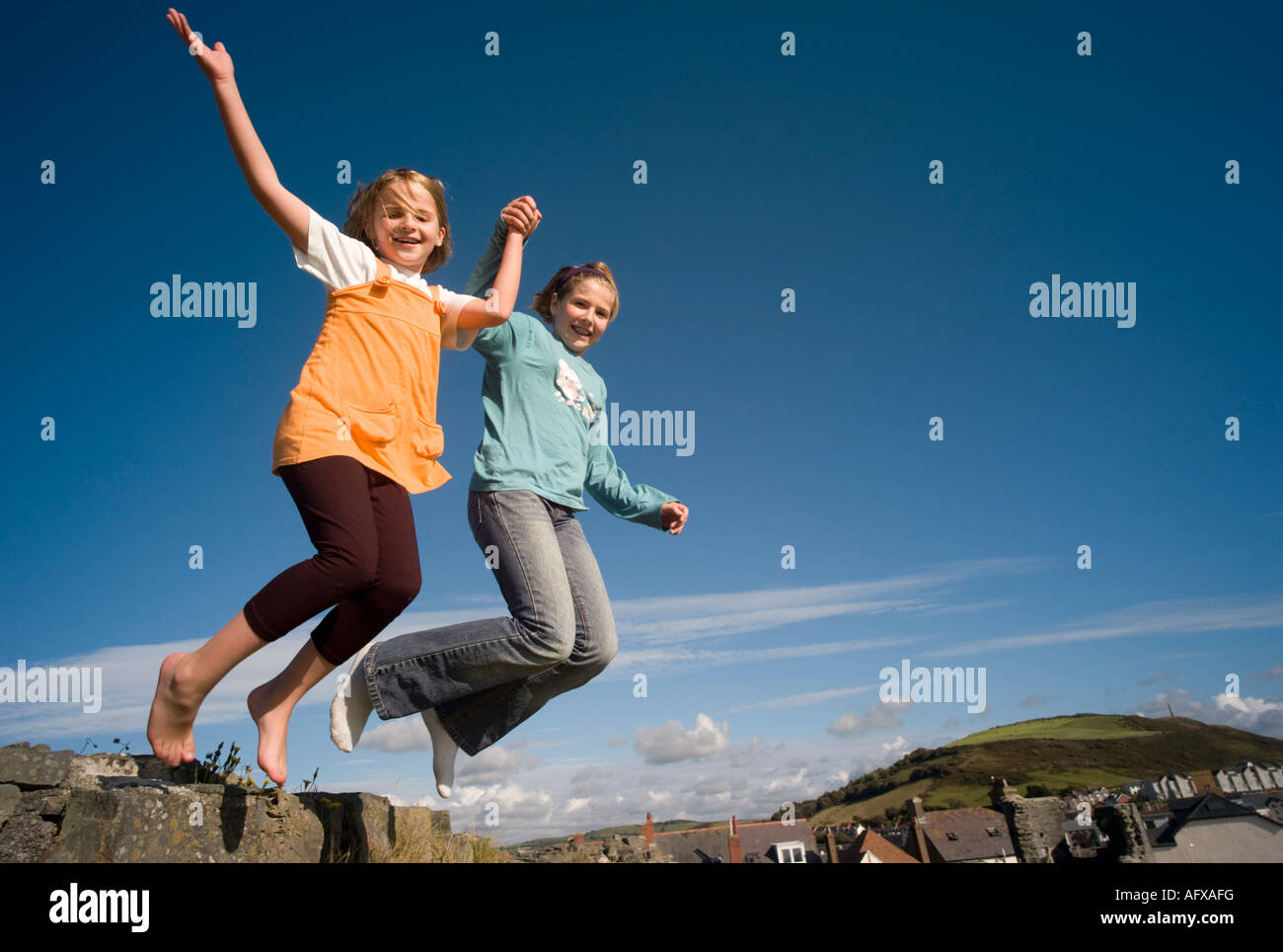 two children leaping in the air with joy fun excitement happiness ...