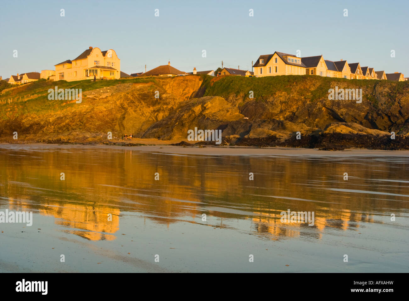 Houses at New Polzeath Cornwall UK reflected in the beach Stock Photo ...