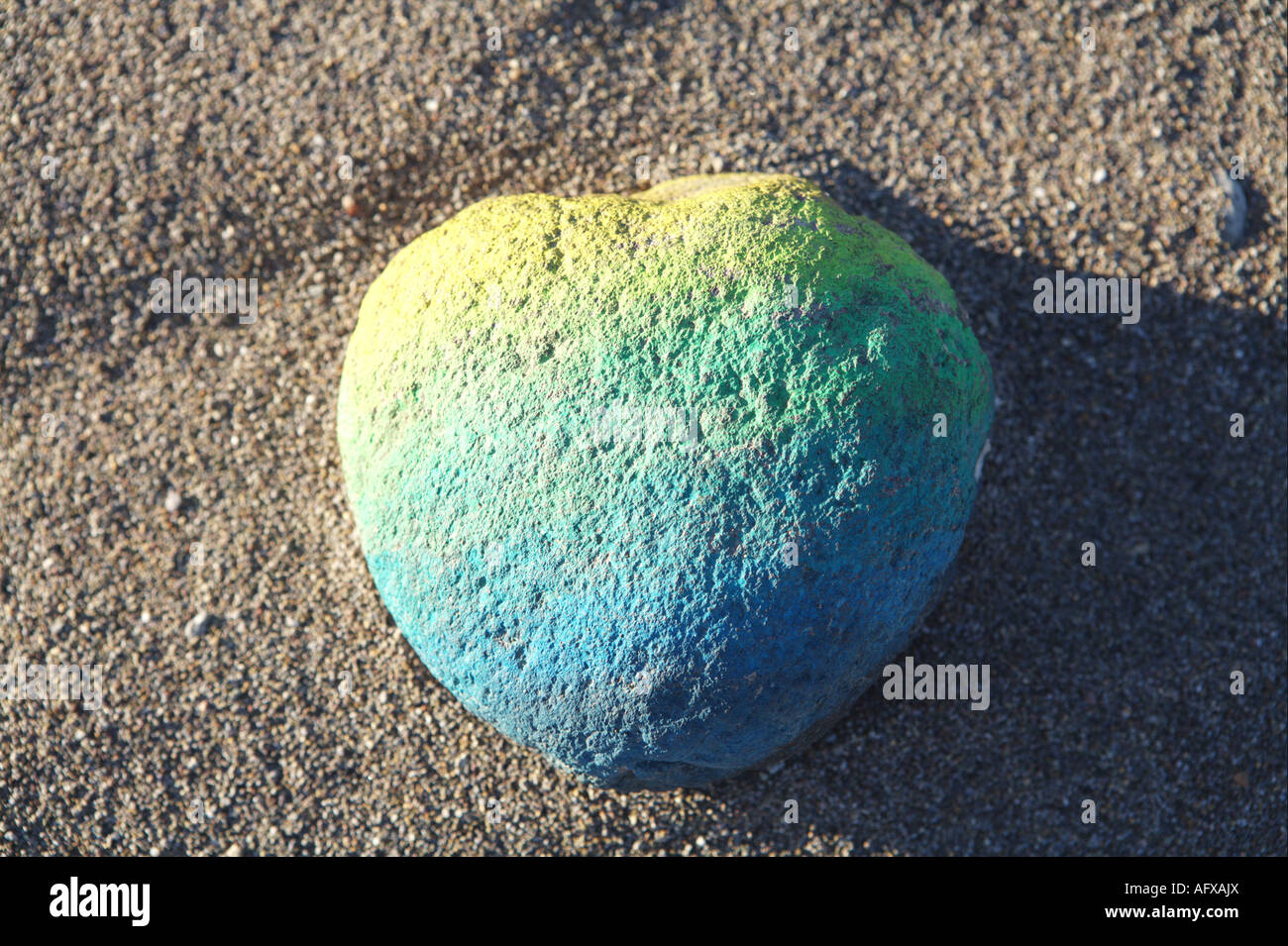 Coloured stone on sand Stock Photo - Alamy