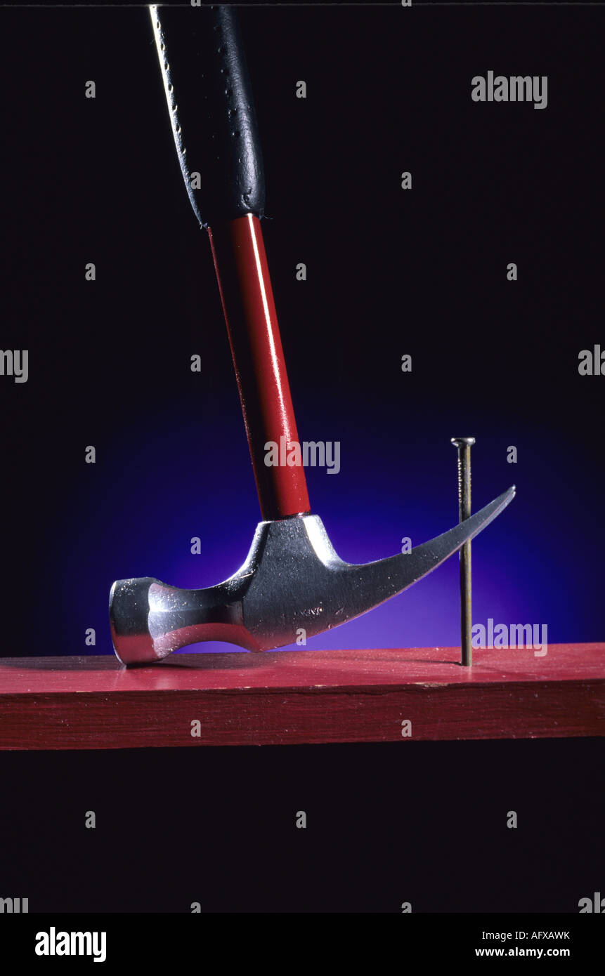 Leverage, Hammer pulling nail from board Stock Photo - Alamy