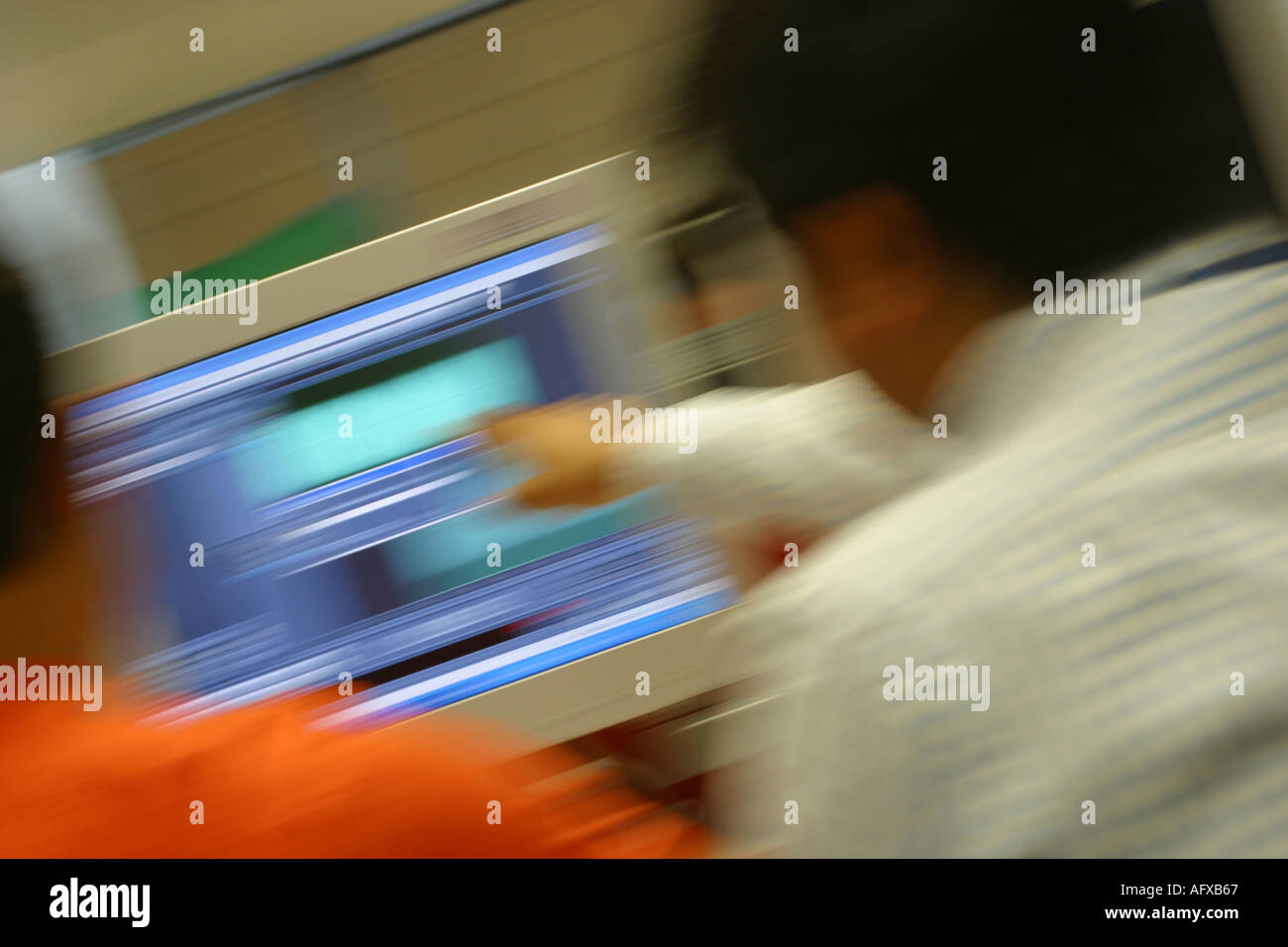 Sound engineers working on a sound file in a broadcast environment ...
