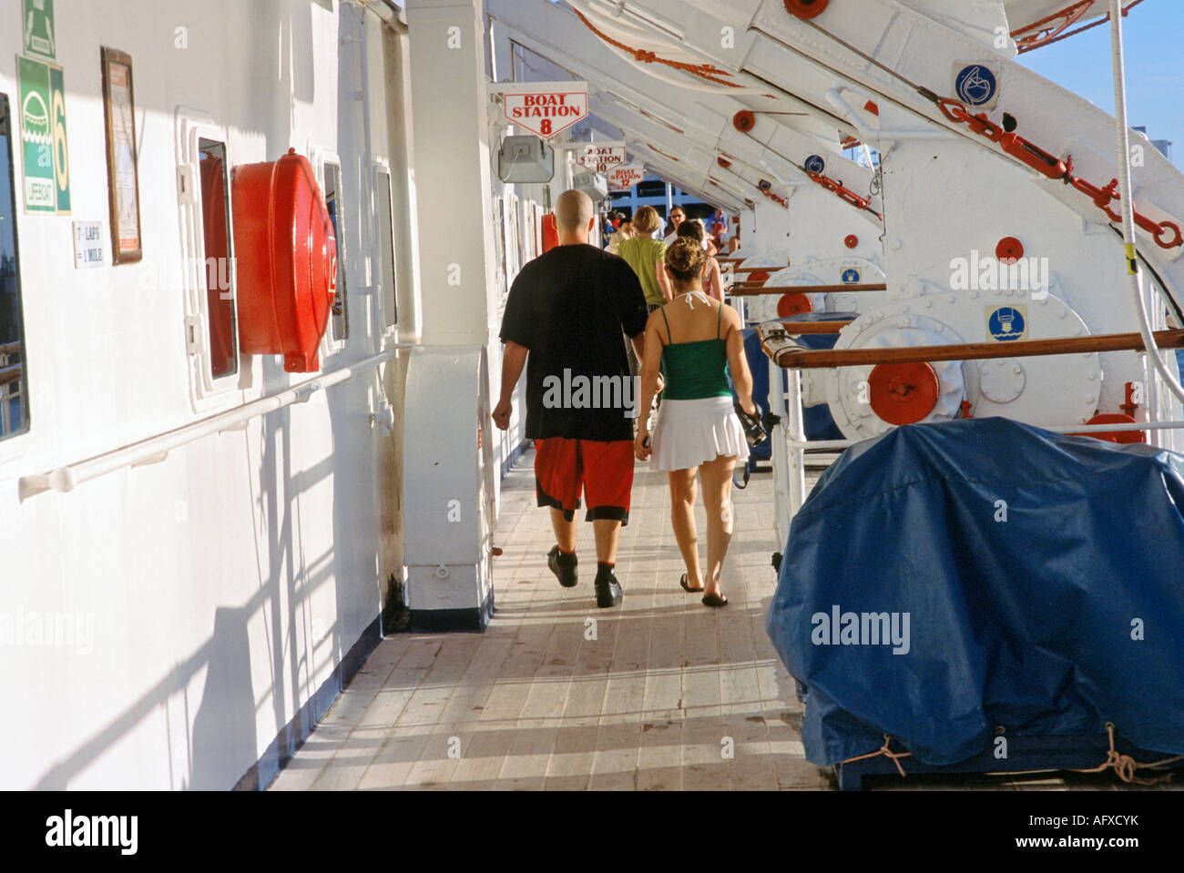 Young couple walking on the side deck of a cruise ship Stock Photo - Alamy