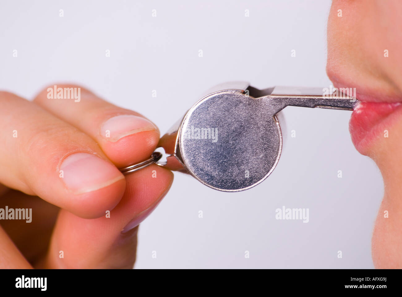 Blowing a whistle Stock Photo - Alamy