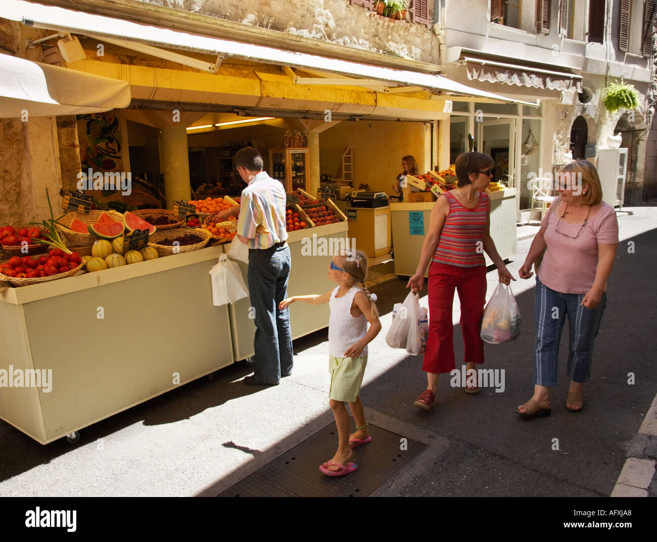 Man shopping for fruit and vegetables at a typical French street market ...