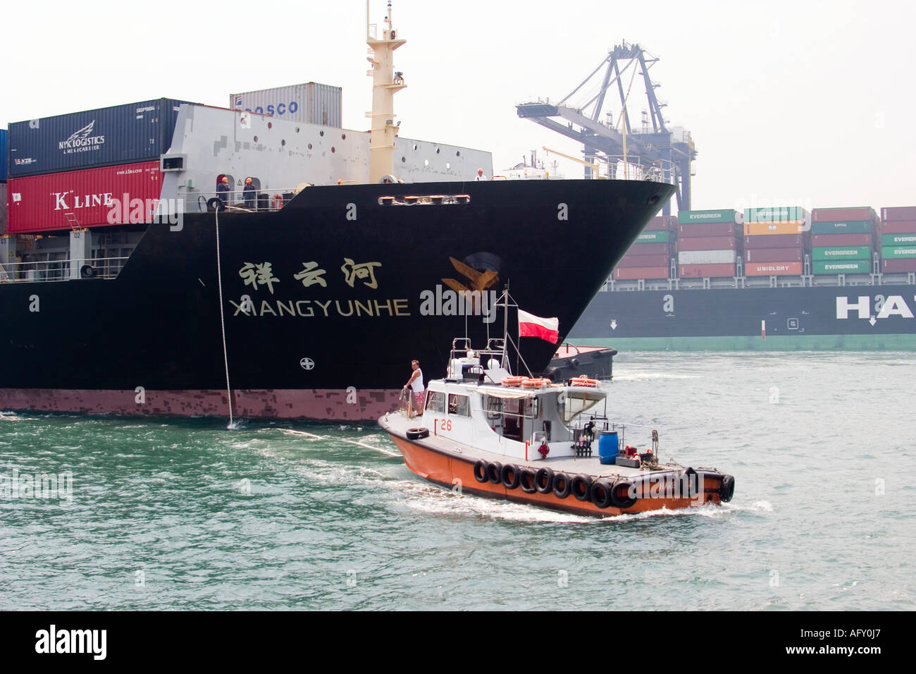 Container Shipping Pilot boat retreives mooring line to pull ship into ...