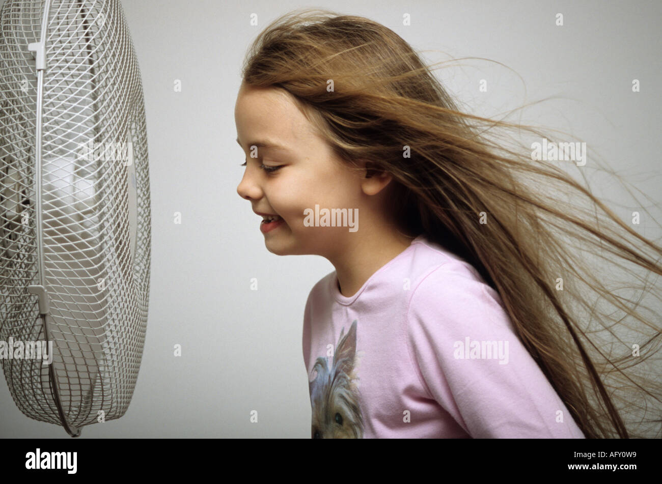 Girl Cools In Front Of Fan Stock Photo - Alamy