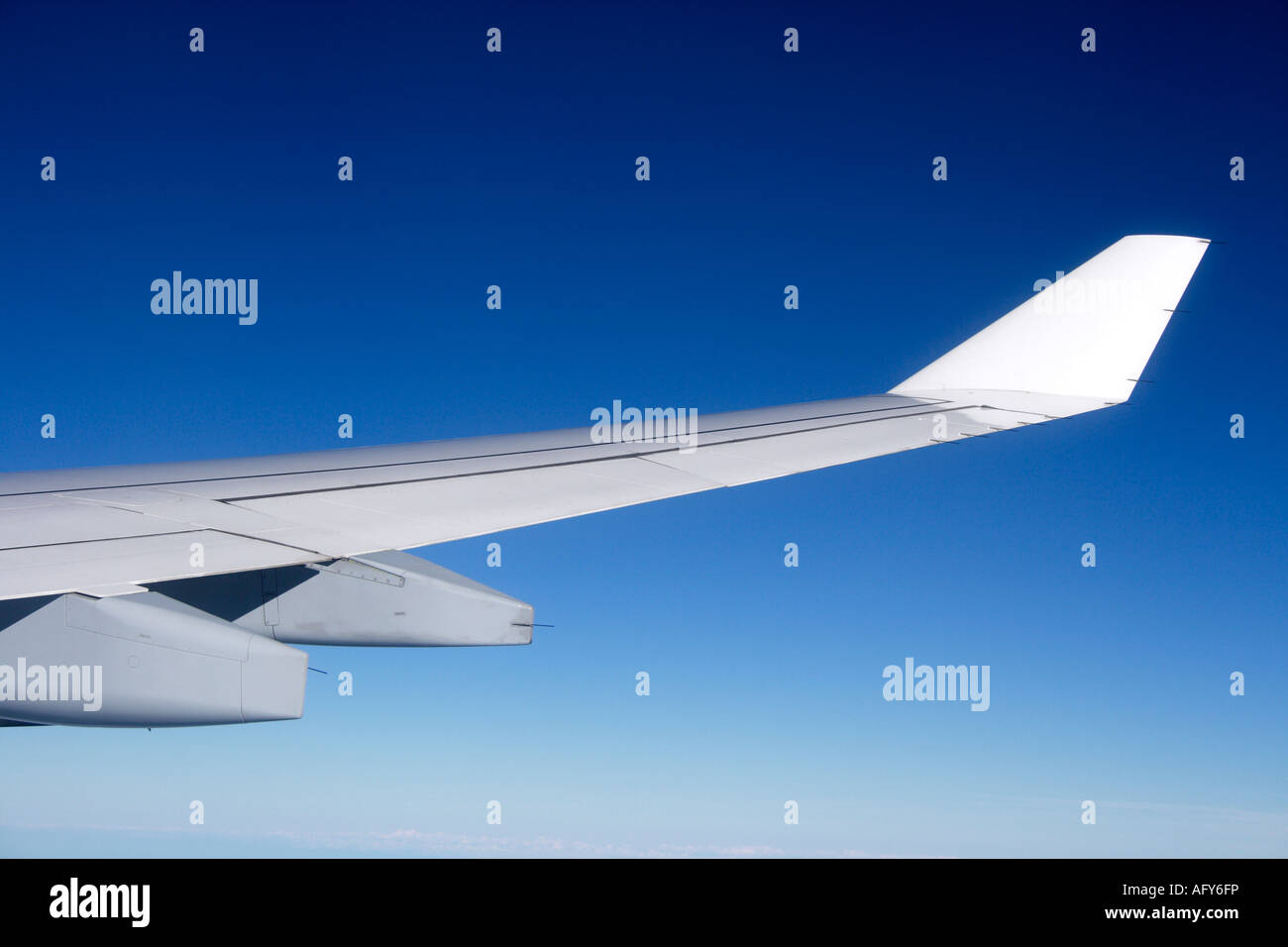 Wing in flight on an aircraft in blue sky. Photo by Willy Matheisl ...