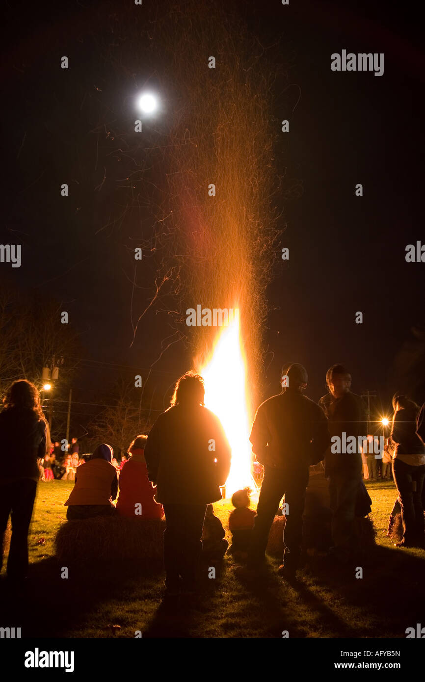 People around a bonfire on a moonlit winter night Stock Photo - Alamy