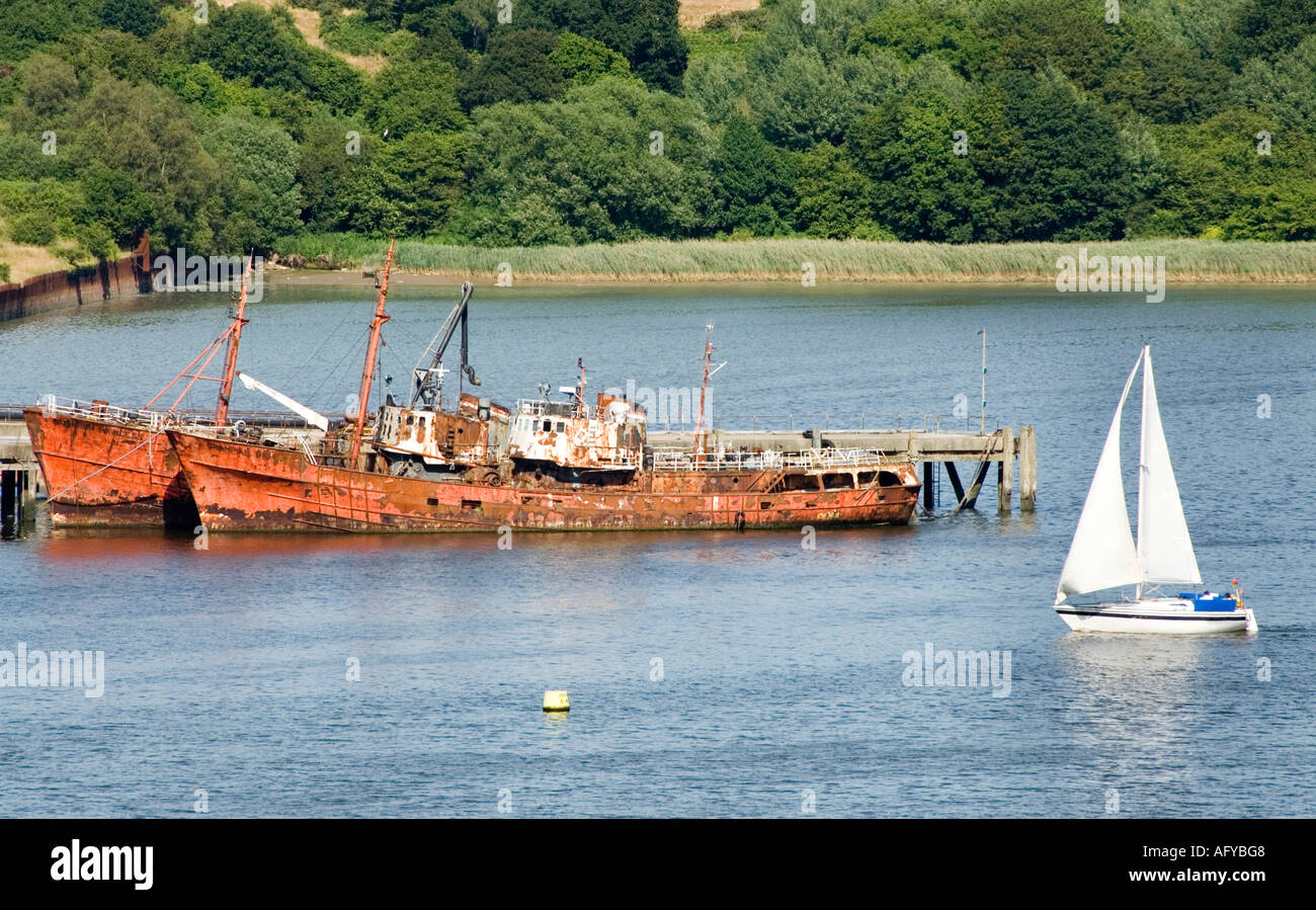 Ipswich the River Orwell two rusting and decaying ships alongside jetty ...