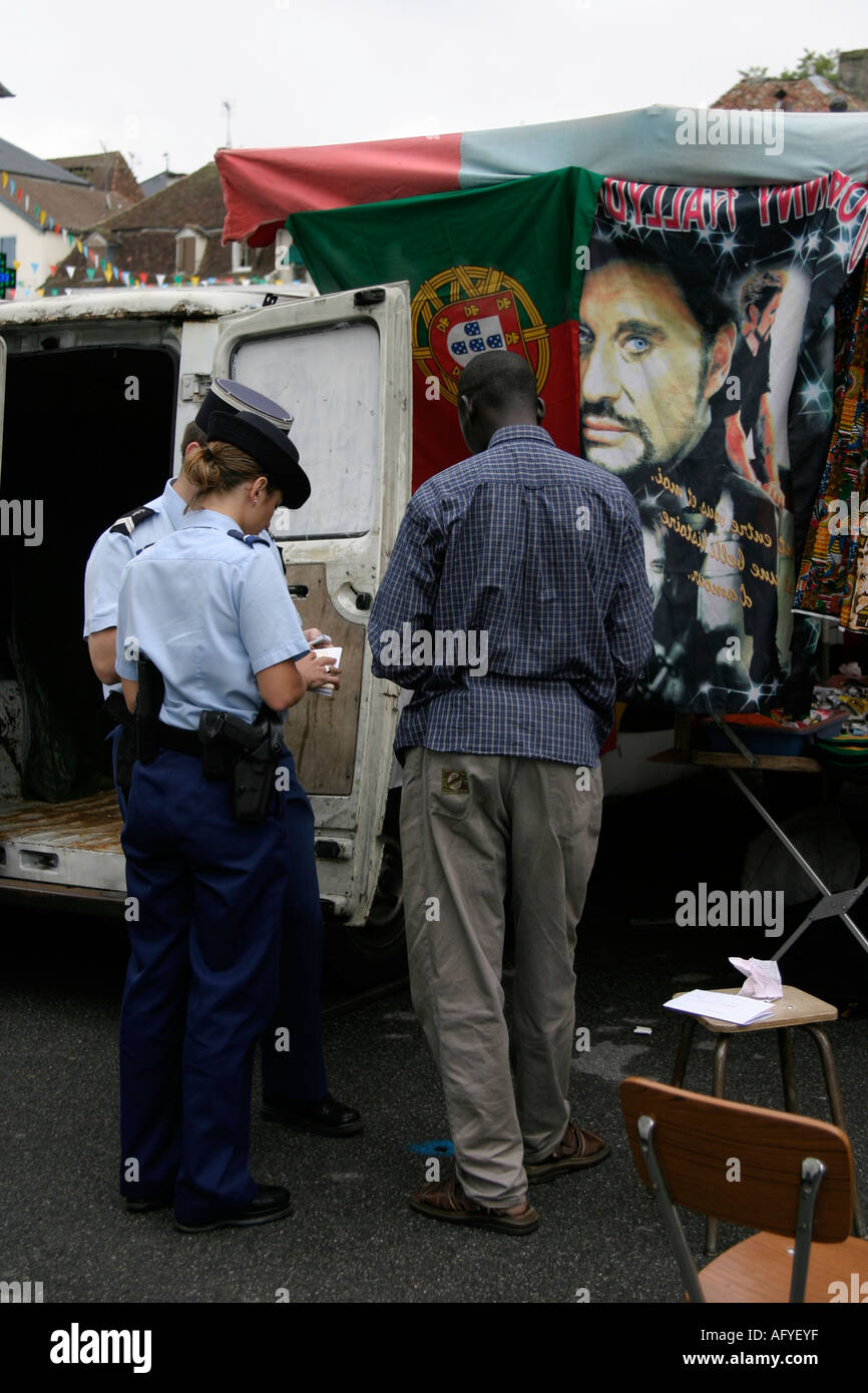 Stock photograph of a market trader and French police Stock Photo - Alamy