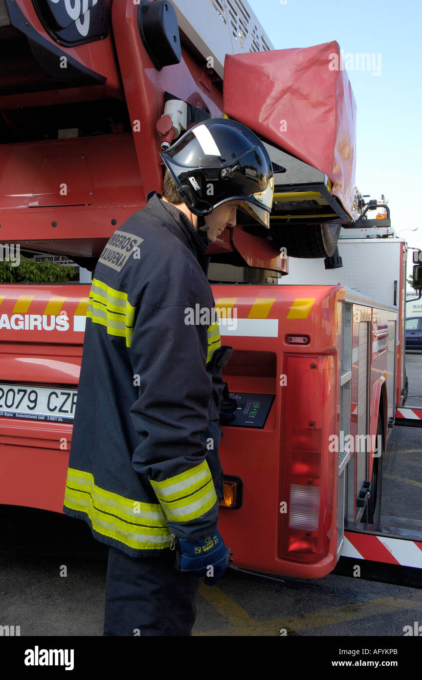 Fireman operating the ladder controls of the fire truck Stock Photo - Alamy