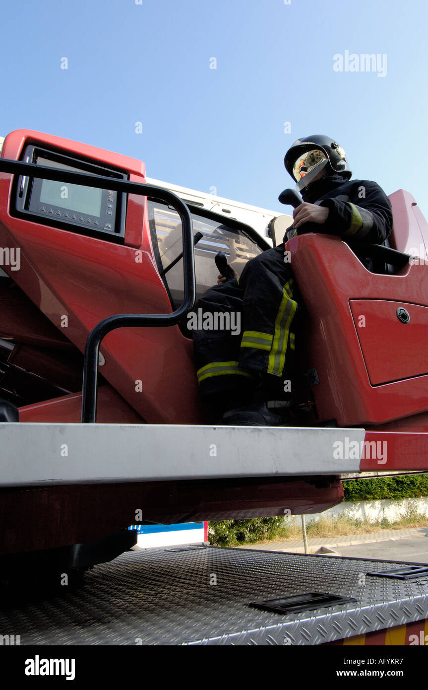 Fireman operating the ladder controls of the fire truck Stock Photo - Alamy
