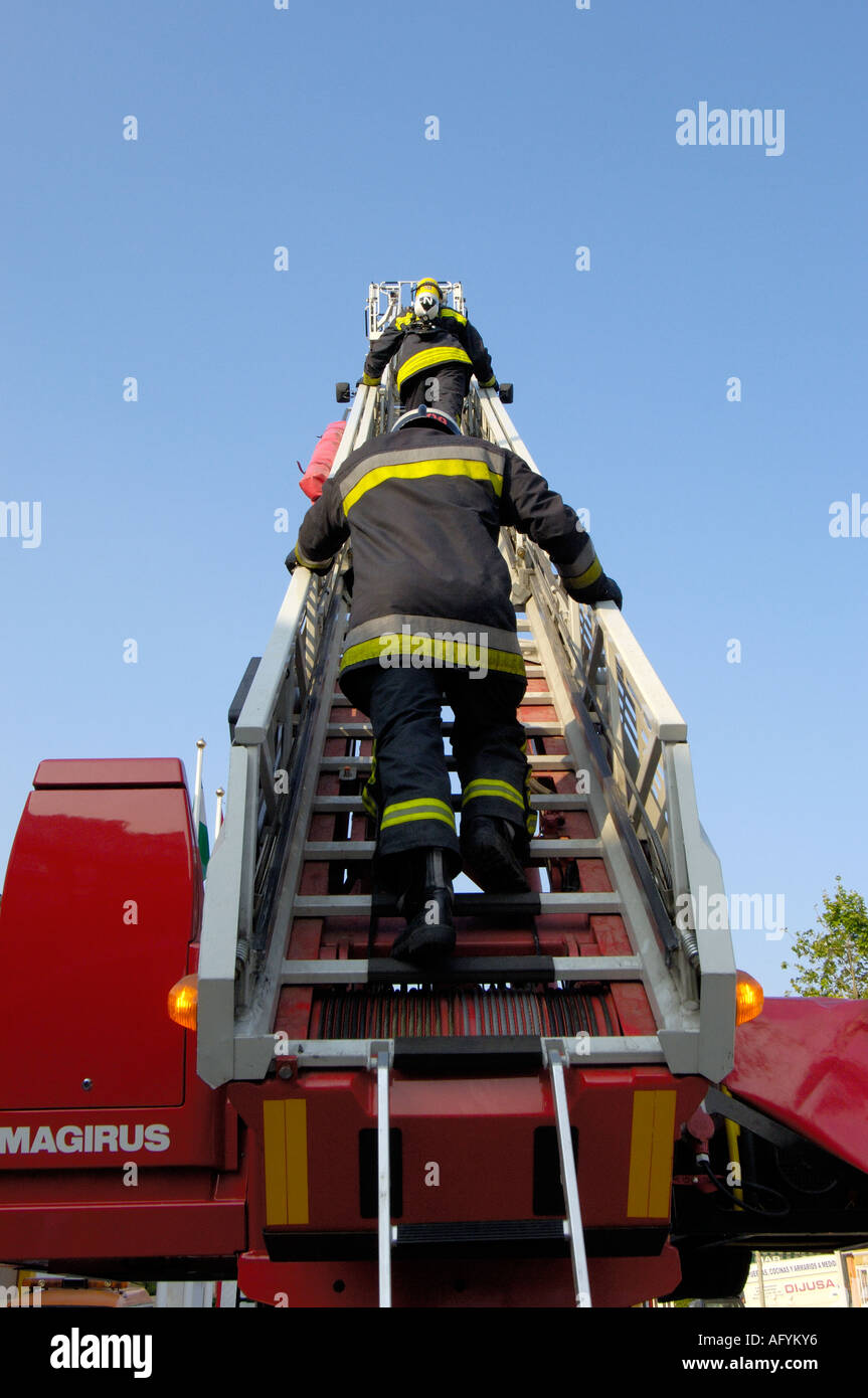 Fireman getting into firetruck Stock Photo - Alamy