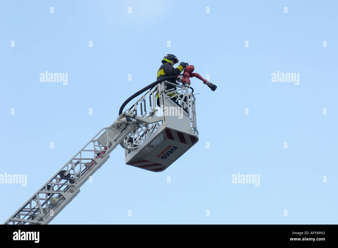 Firemen using water cannon Stock Photo - Alamy