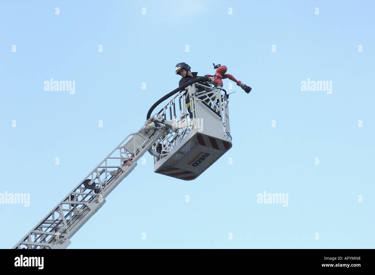 Firemen using water cannon Stock Photo - Alamy