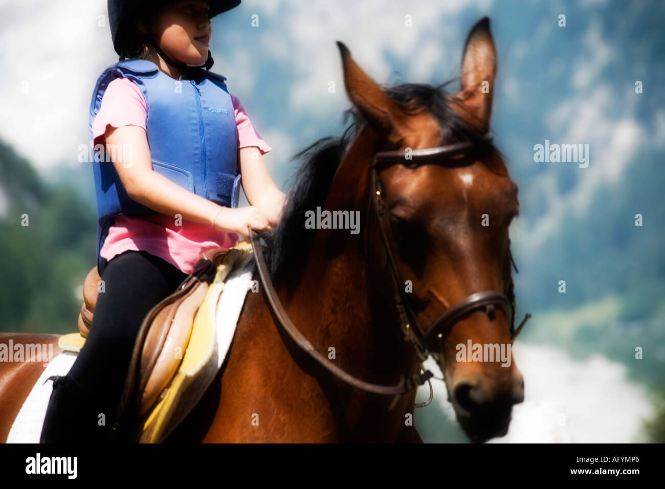Child learning to ride horse Stock Photo - Alamy