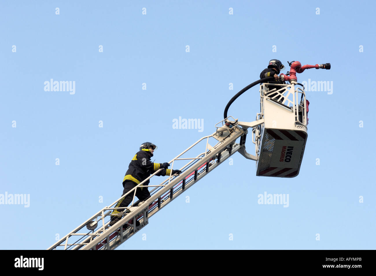 Firemen using water cannon Stock Photo - Alamy
