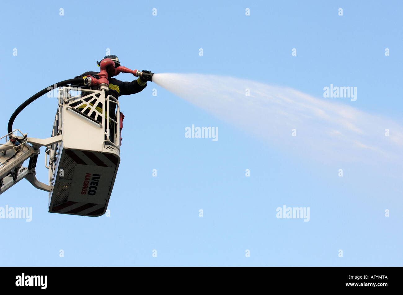 Firemen using water cannon Stock Photo - Alamy