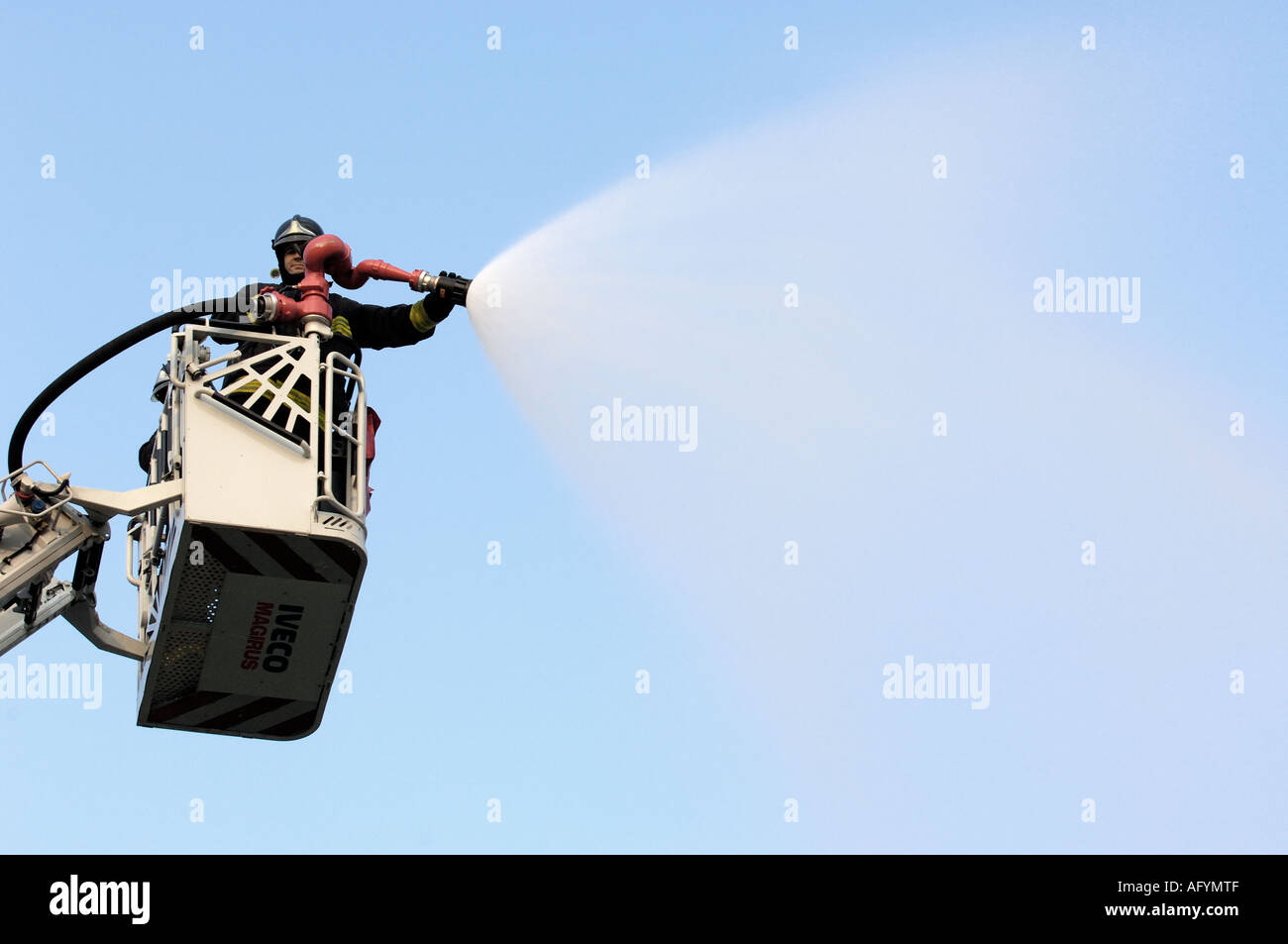 Firemen using water cannon Stock Photo - Alamy