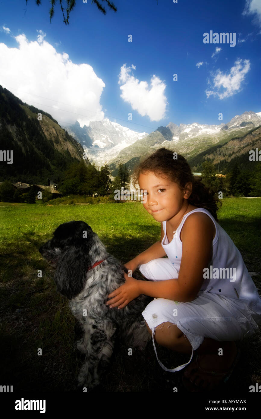 dog and little girl on holiday in the Alps. Curmayeur, Italy Stock ...