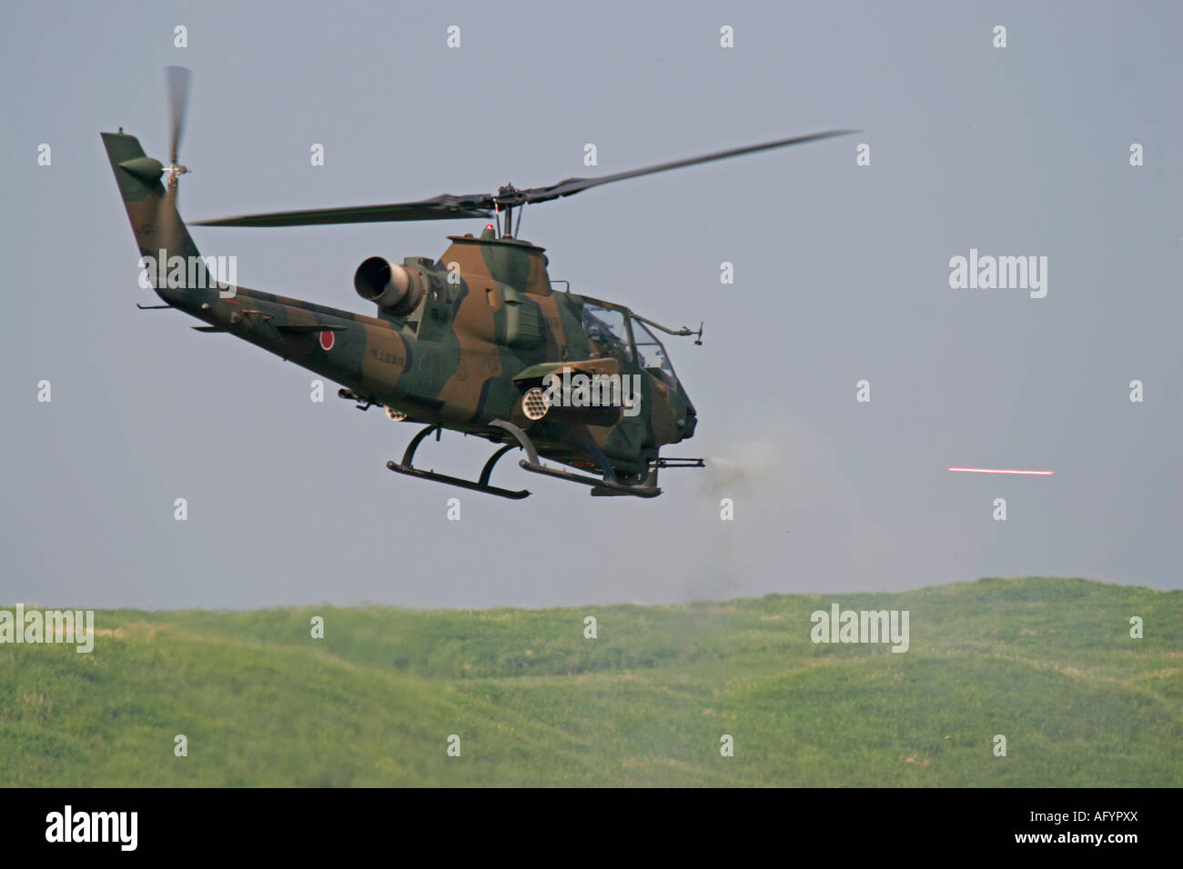 Japan Ground Self Defence Force AH-1 Cobra helicopter firing 20mm ...