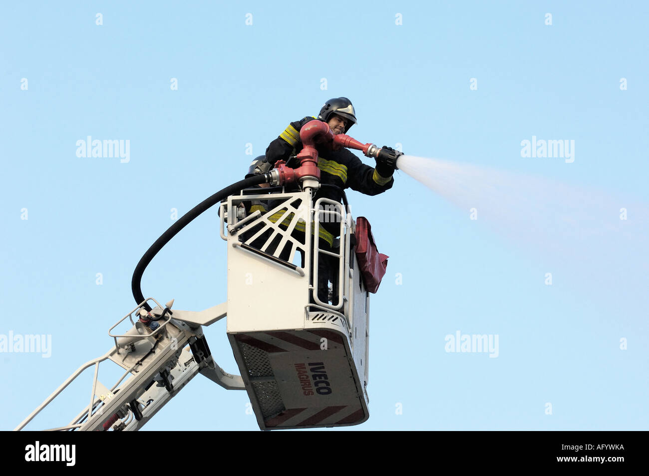 Firemen using water cannon Stock Photo - Alamy